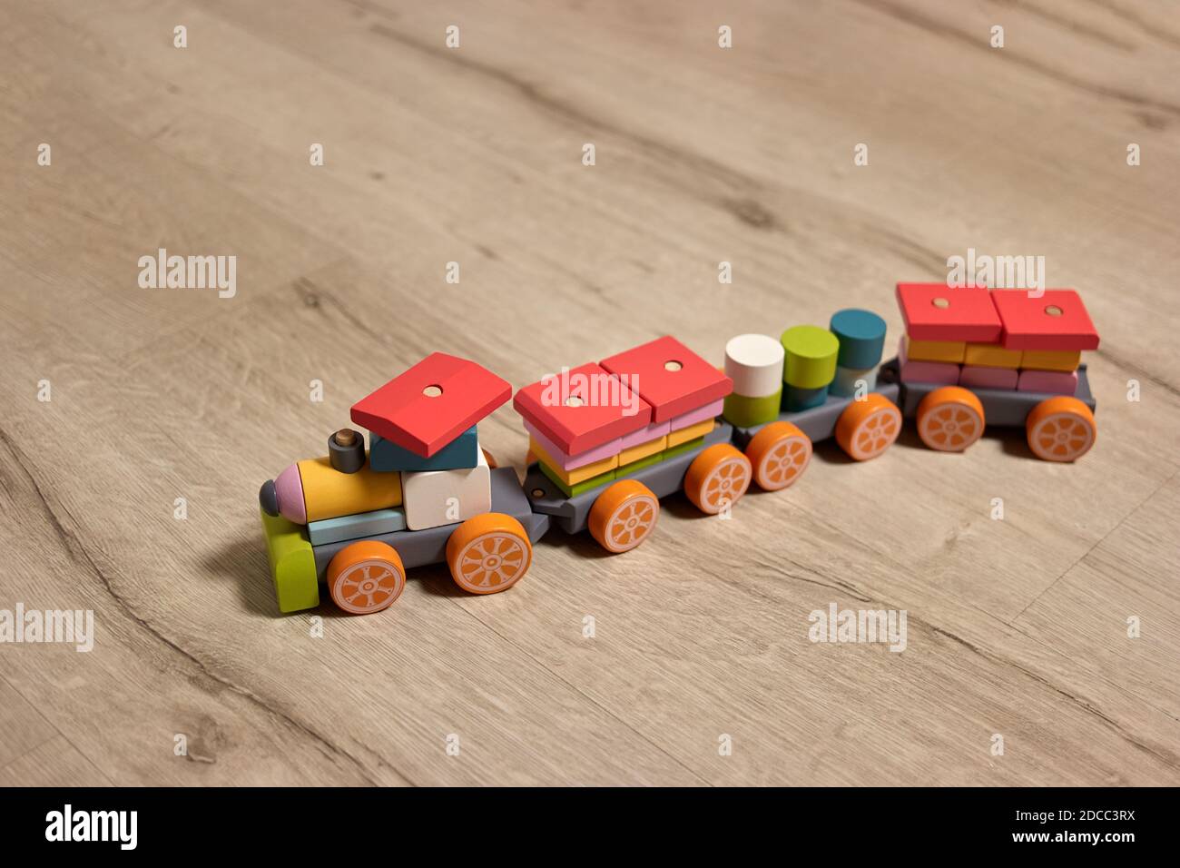 Wooden toy train with colorful blocks Stock Photo - Alamy