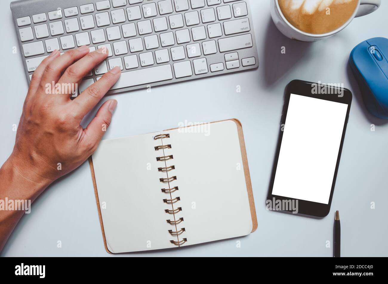 Mobile phone mockup man hand using computer keyboard Note book, coffee ...