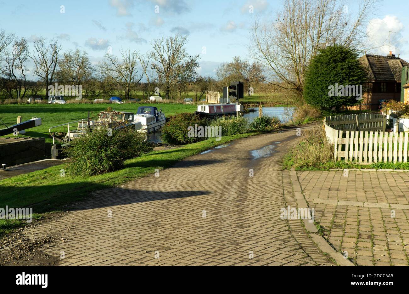 Block paved road next to a canal lock Stock Photo - Alamy