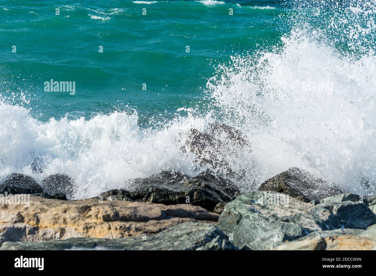 Waves of Persian Gulf splashing the stones of breakwater at the ...