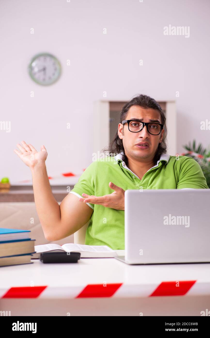 Male student studying at home in self-isolation concept Stock Photo - Alamy