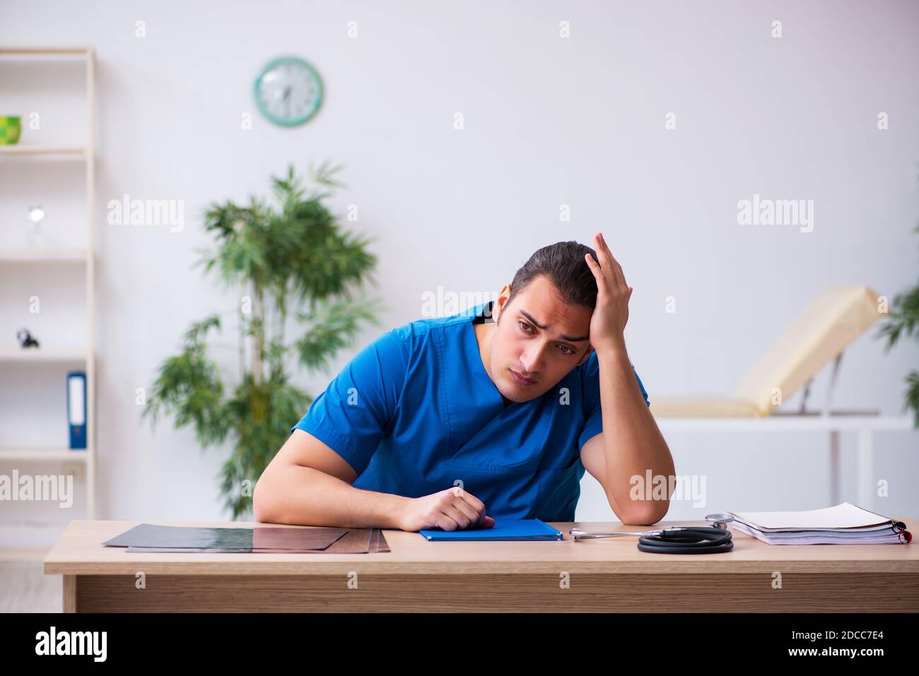 Young doctor being extremely tired after night shift Stock Photo - Alamy