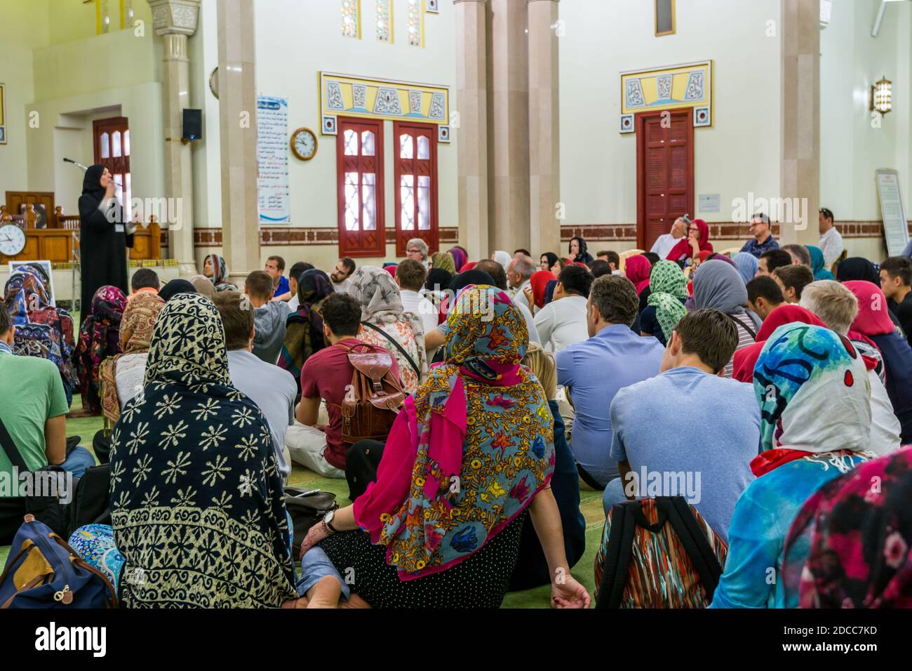 Non-Muslim guests listening a lecture from a Muslim female teacher ...