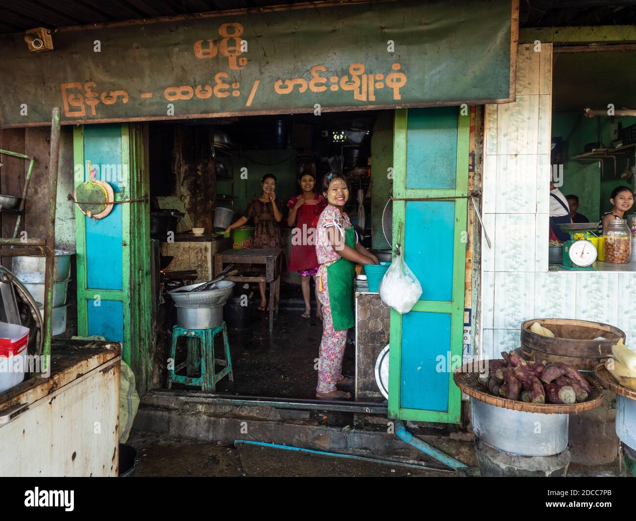 Restaurant kitchen with kitchen staff wearing the traditional thanaka ...