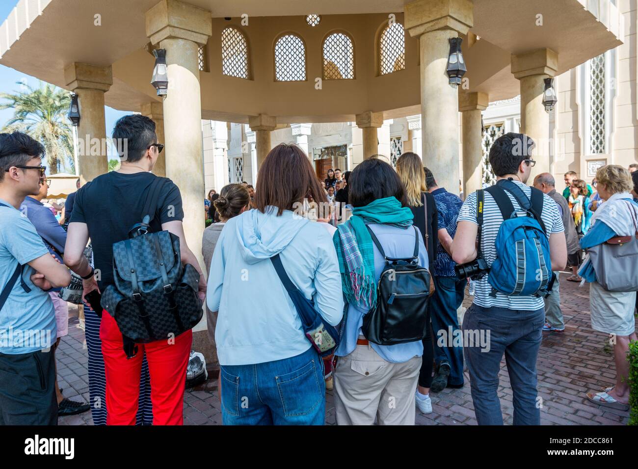 Tourist standing at the ablution taps of Wudu pavilion Jumeirah Mosque ...