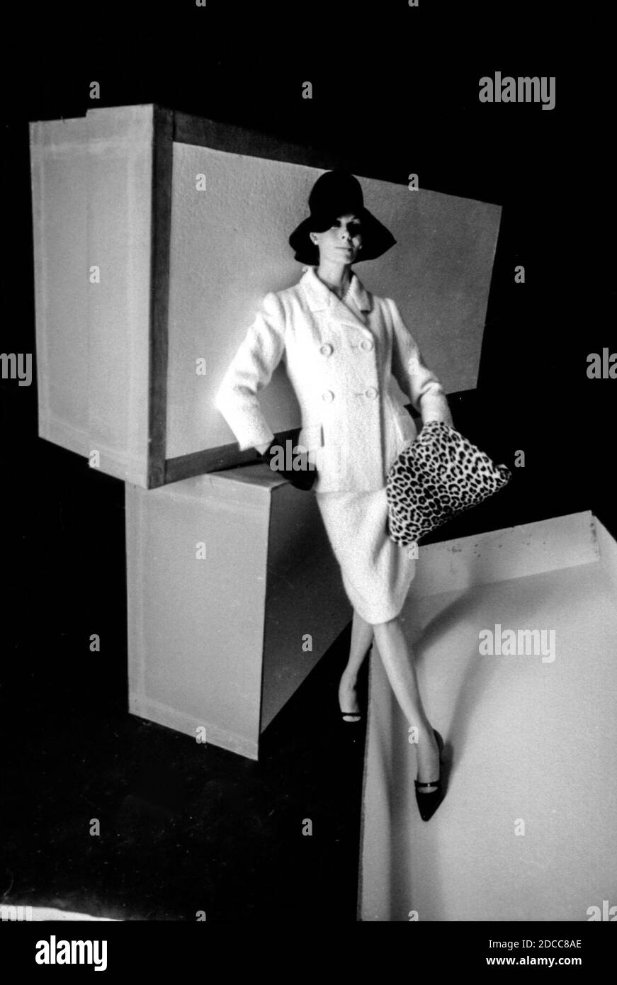 A fashion model poses with large shoe boxes in a shoot for Harpers ...