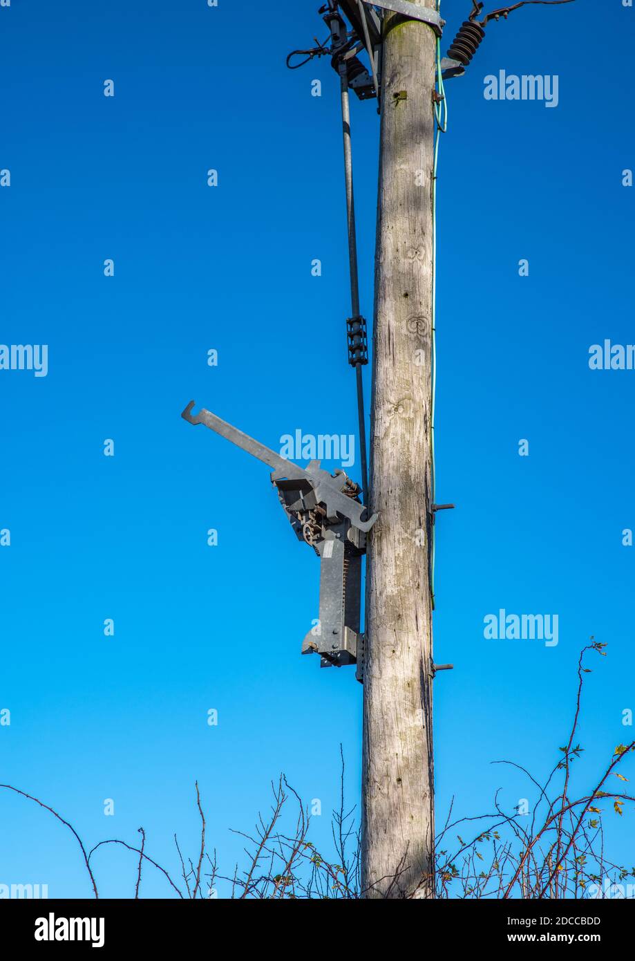 Wooden telegraph pole with wires and insulators with a clear blue sky ...