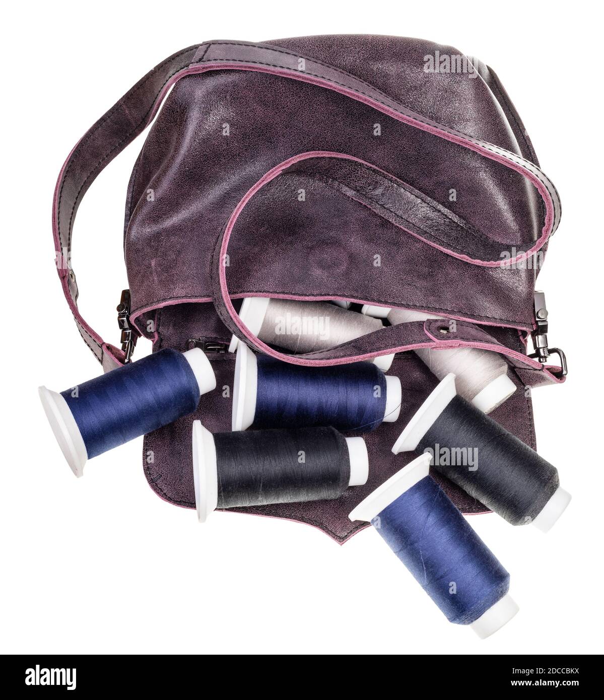 spools of sewing threads fell out from open women's bag isolated on ...