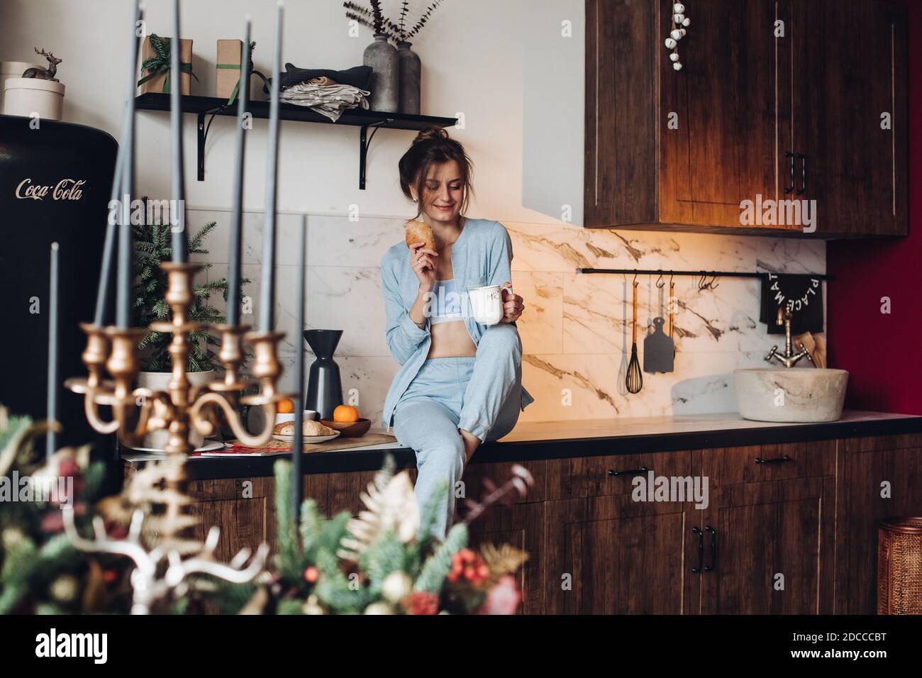 Beautiful young lady having breakfast in her kitchen Stock Photo - Alamy