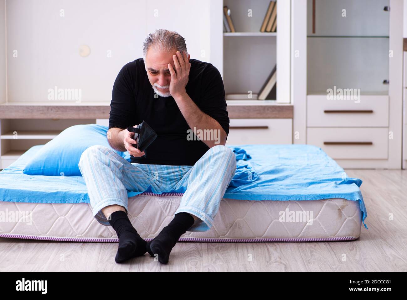 Old man in depression mode at home Stock Photo - Alamy