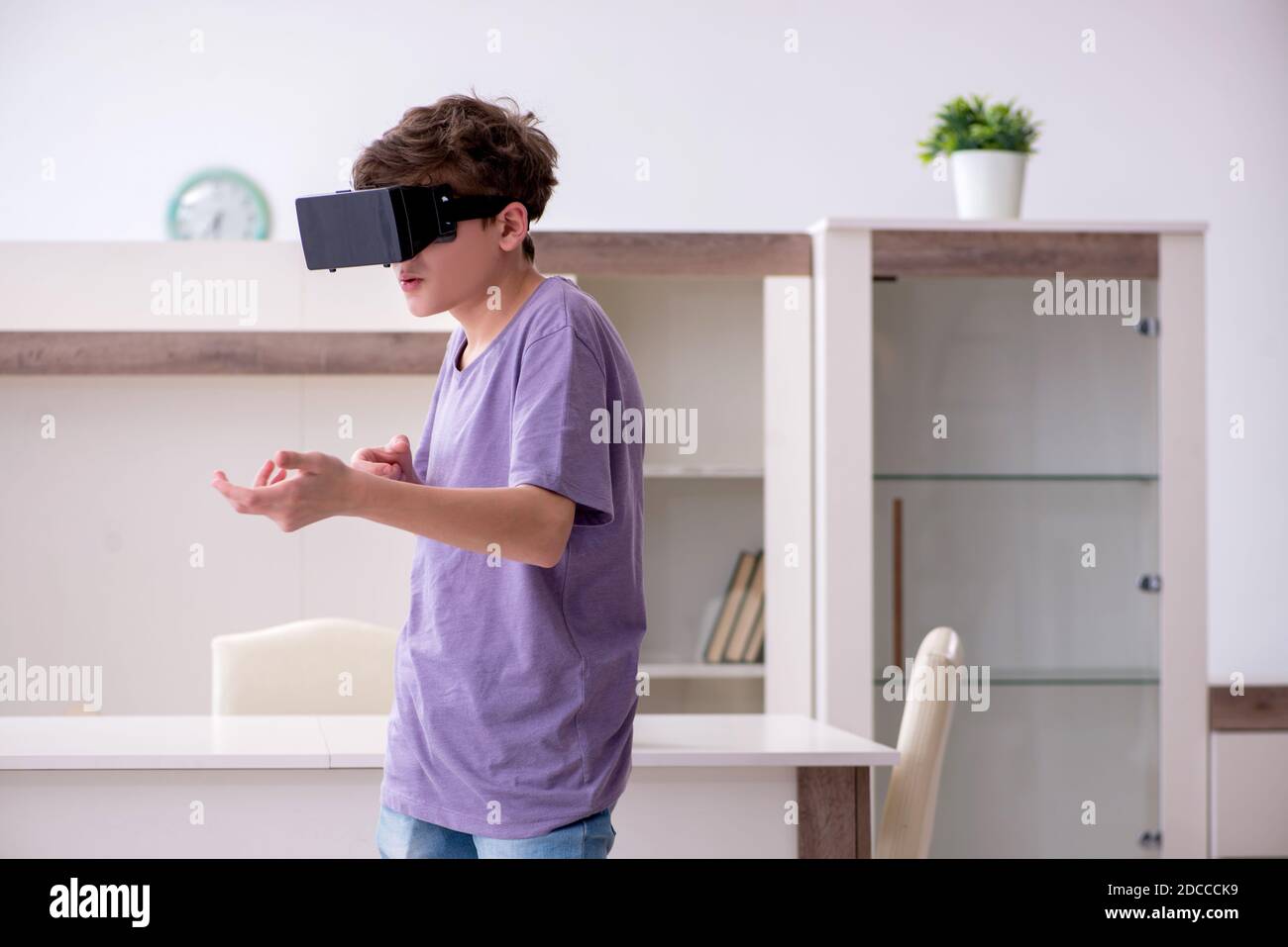 Boy wearing virtual glasses at home Stock Photo - Alamy