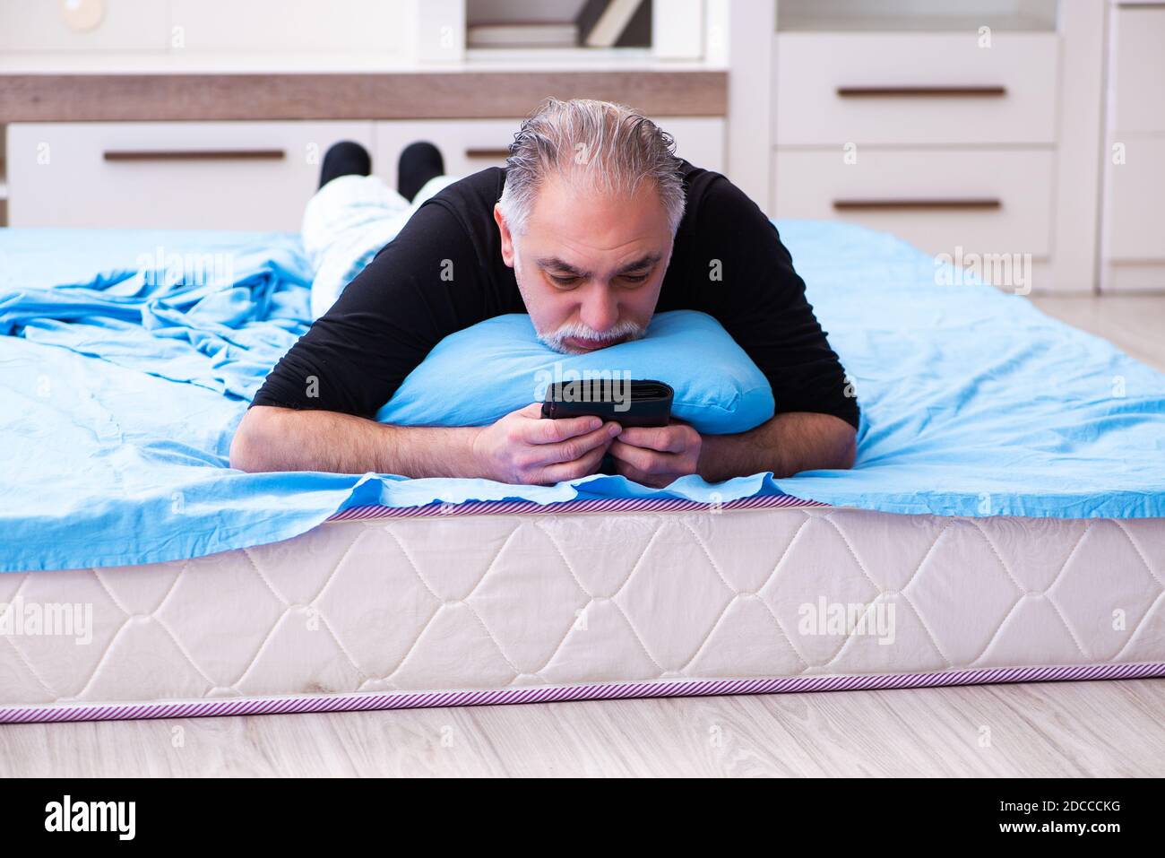 Old man in depression mode at home Stock Photo - Alamy