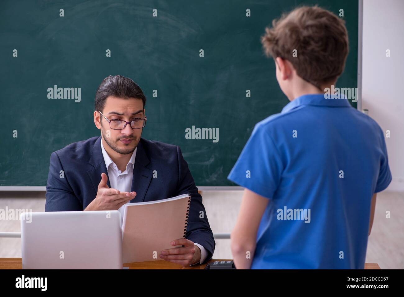 Male teacher and schoolboy in the classroom Stock Photo - Alamy