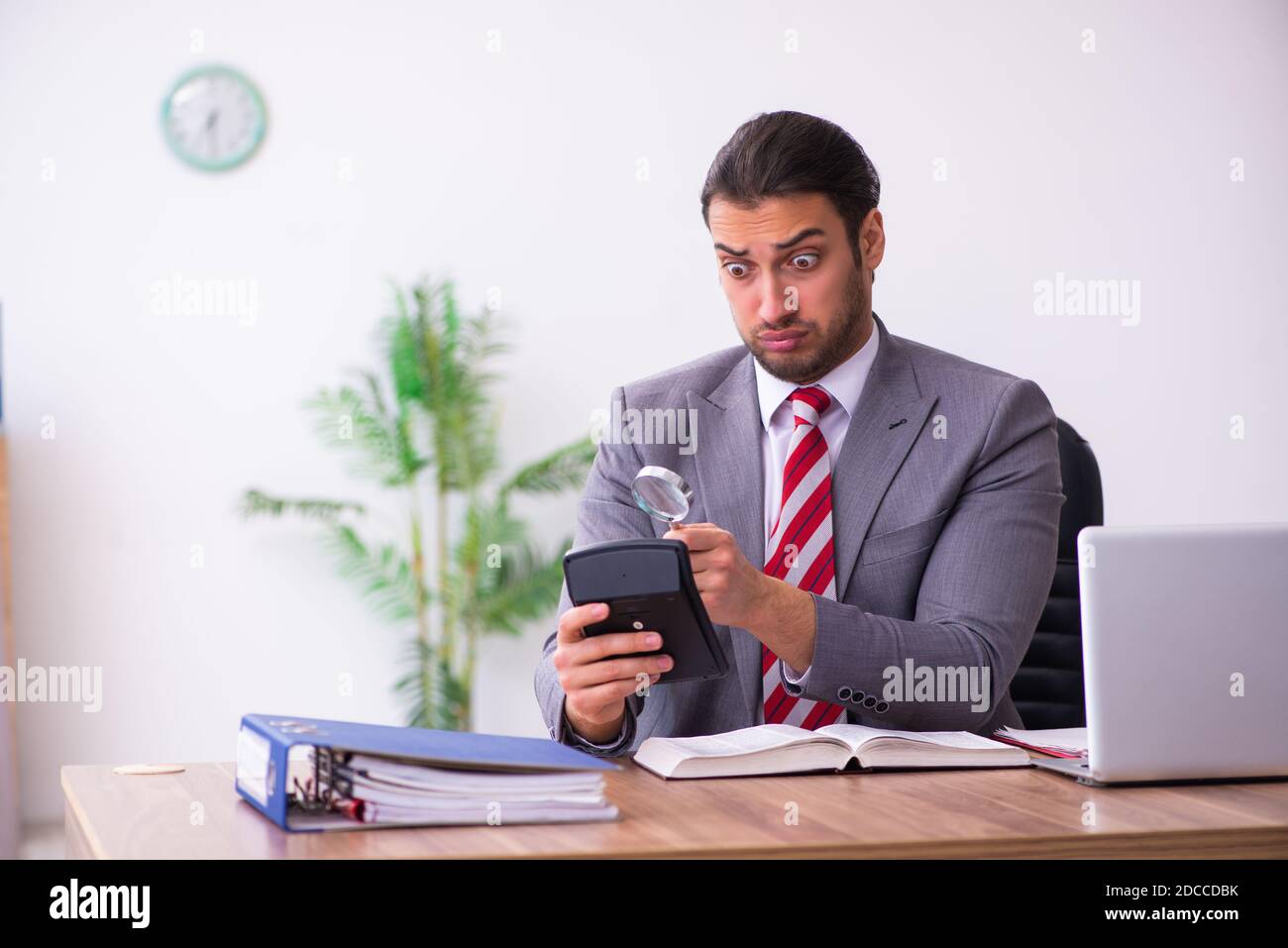 Male bookkeeper working in the office Stock Photo - Alamy