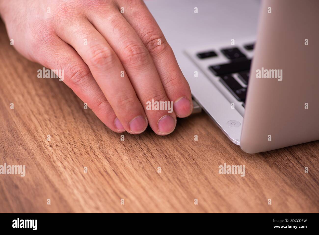 Male employee inserting flash drive into laptop Stock Photo - Alamy