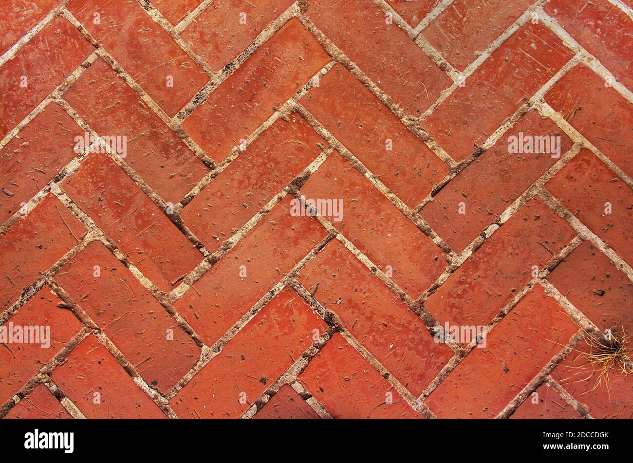 Paved footpath. Old red brick paving on a sidewalk. Abstract background ...