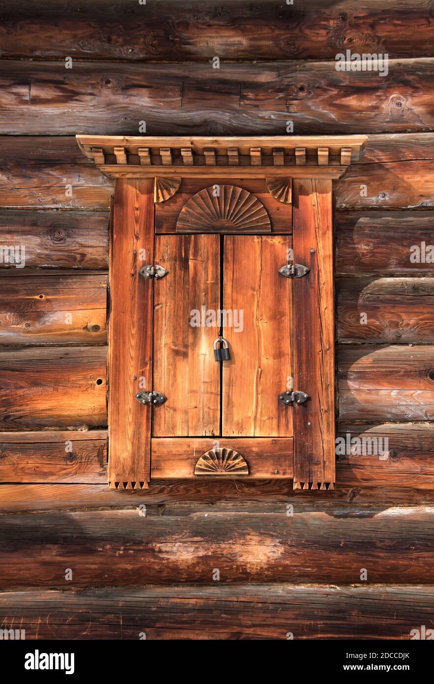 Carved wooden window. Old wooden window shutters on a log wall ...