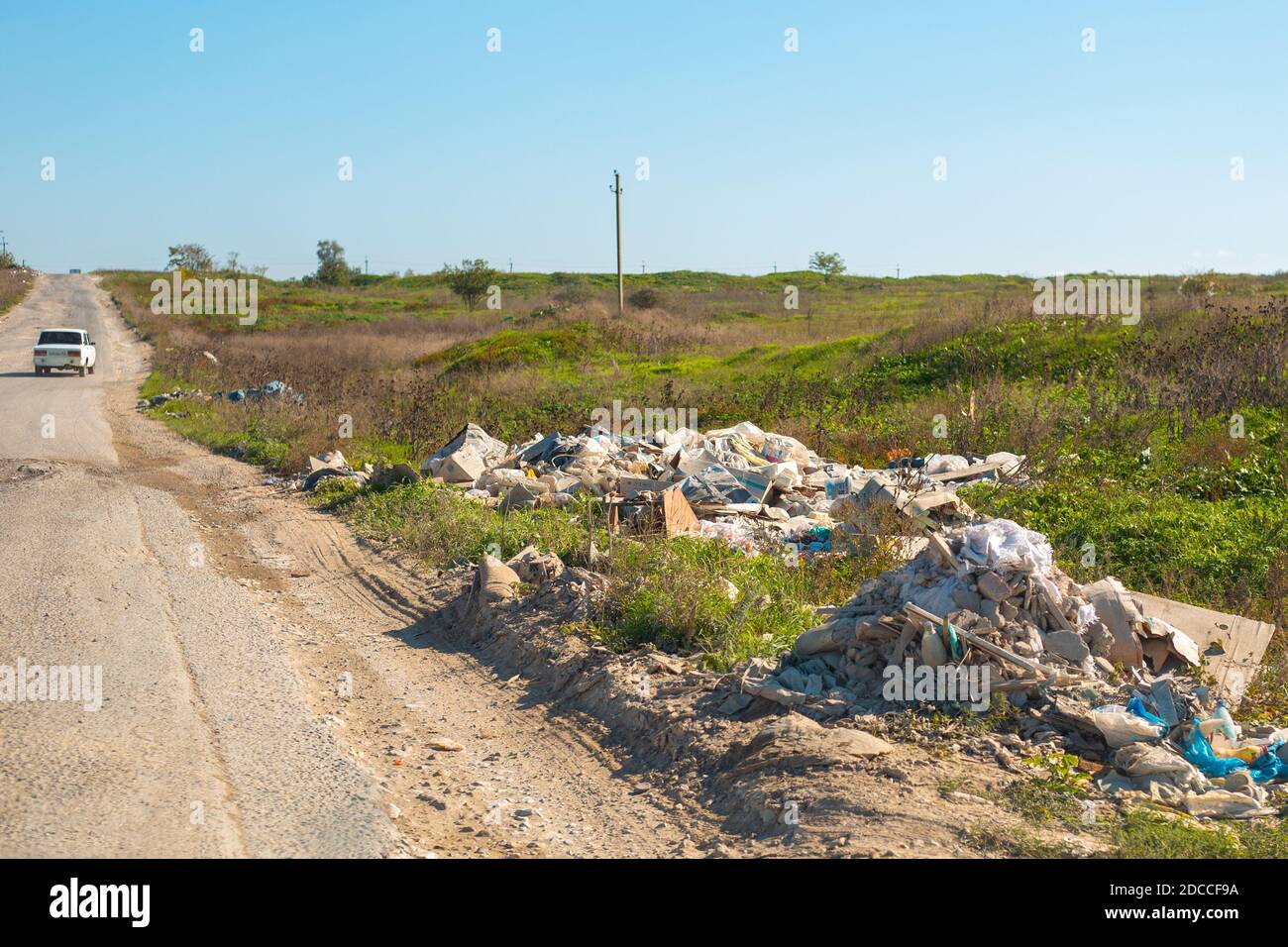 a pile of rubbish on the side of the road. The global problem of ...