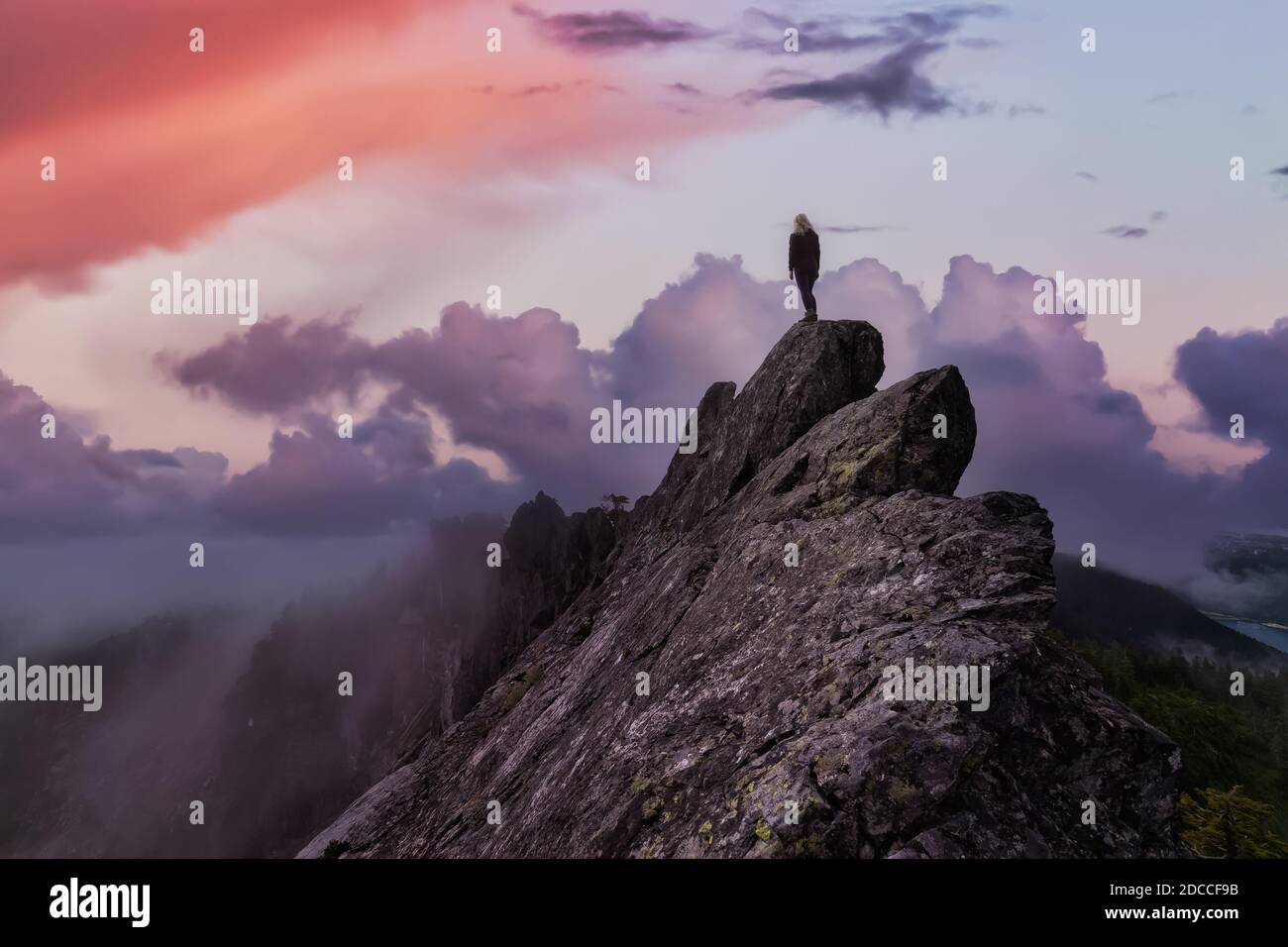 Adventurous Girl on top of a Mountain Peak Stock Photo - Alamy