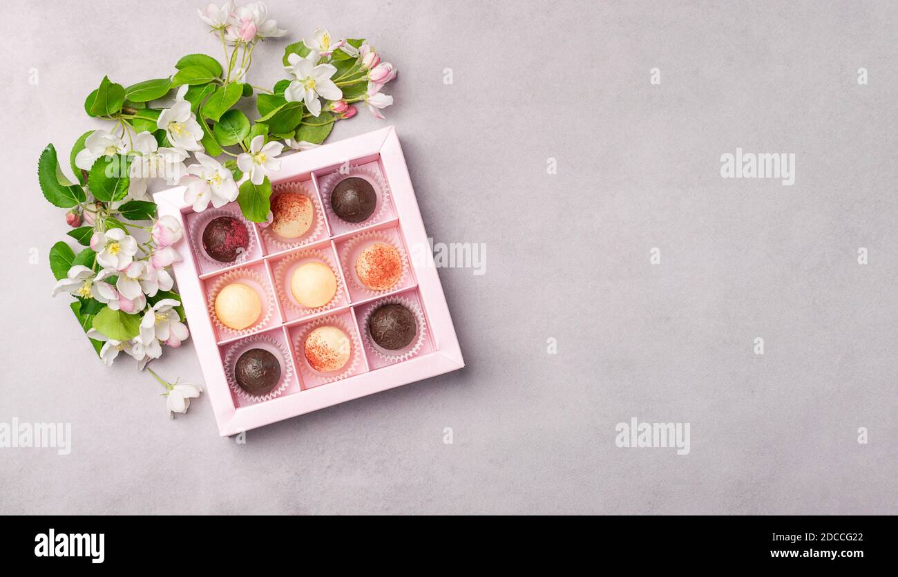 Chocolate candies in a festive box on a gray background. Holiday ...