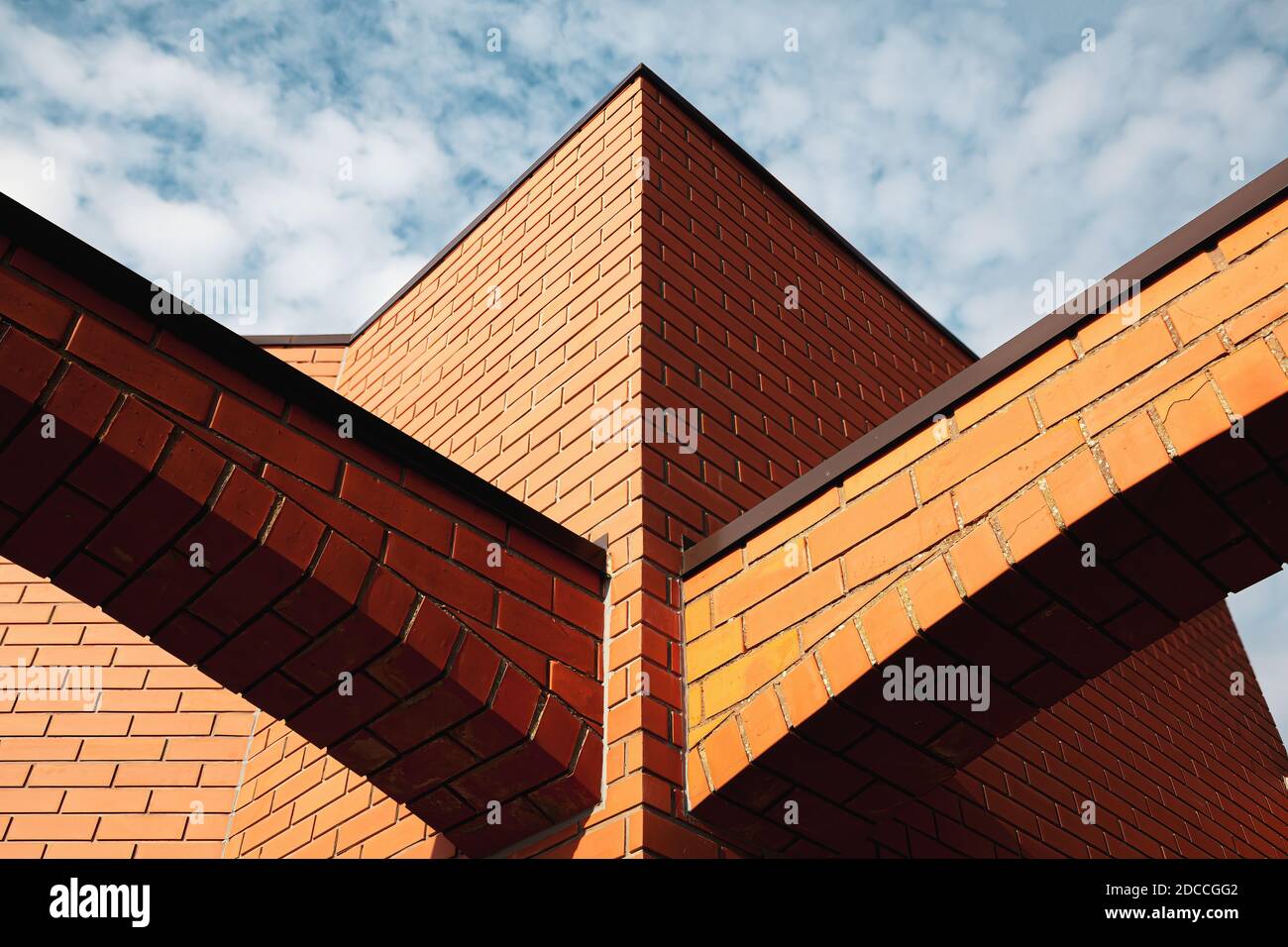 Corner of a brick building with arches on a background of blue sky with ...