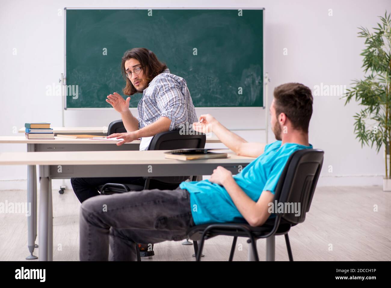 Male pupils in bullying concept in the classroom Stock Photo - Alamy