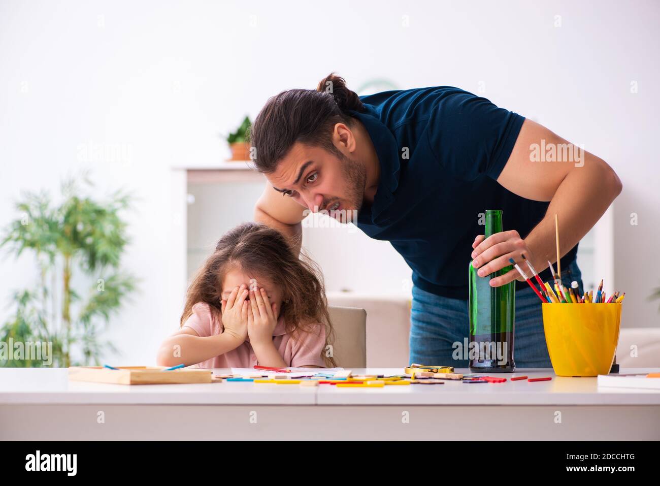 Drunk father and little girl at home Stock Photo - Alamy