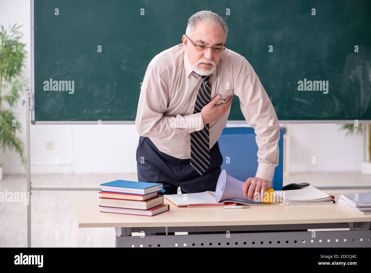 Old experienced teacher in the classroom Stock Photo - Alamy
