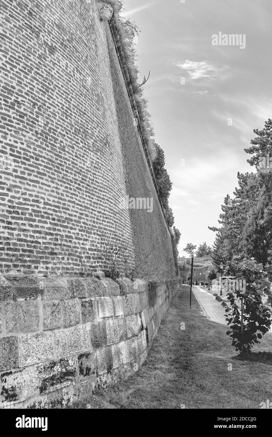 A grayscale vertical shot of a brick-made building exterior walls Stock ...
