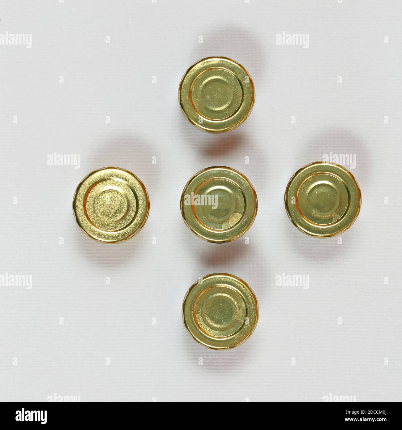 Five Small Jars With Golden Lids Stock Photo - Alamy