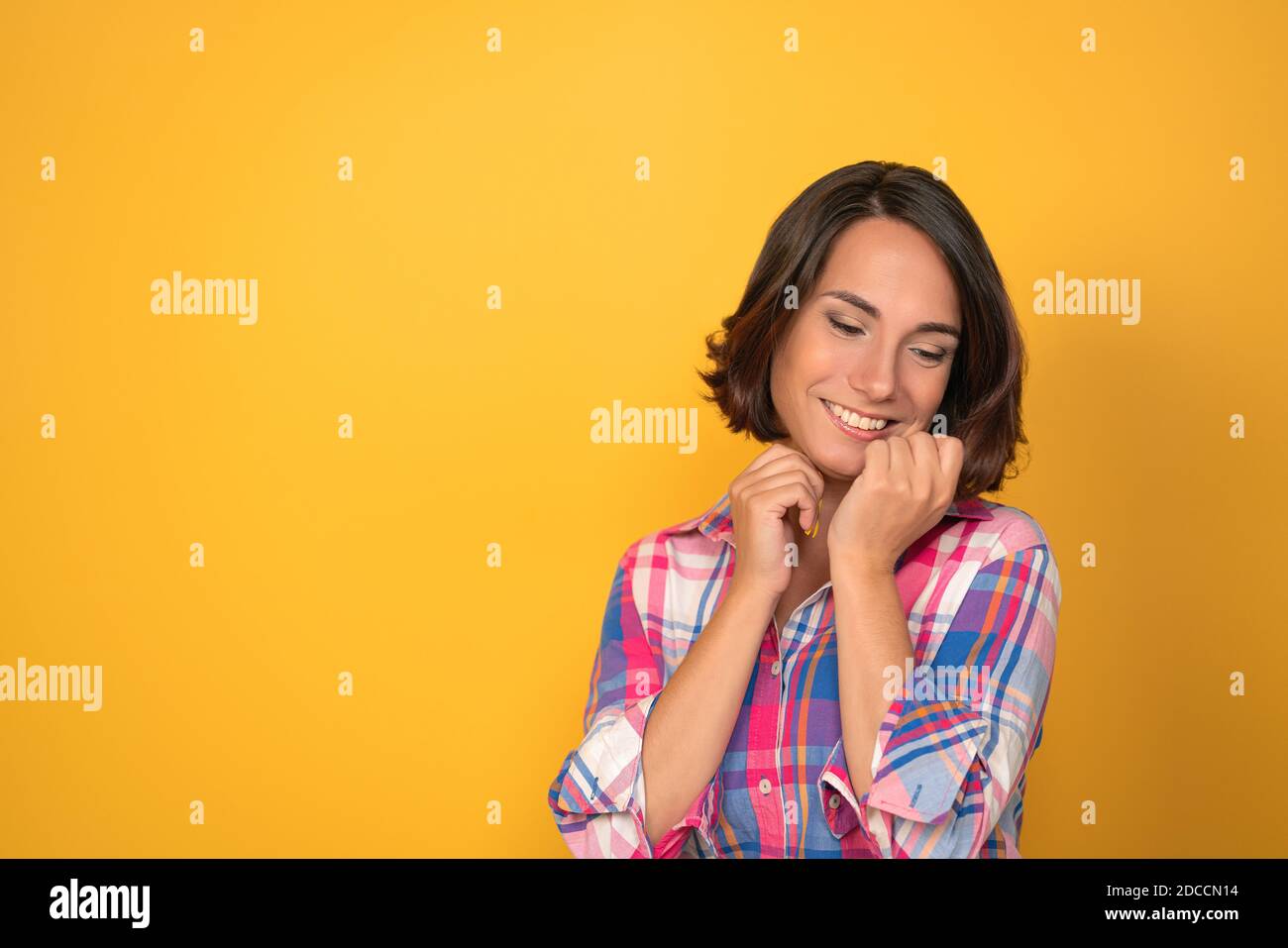 Charming woman expressing tenderness and saying good bye in plaid shirt ...
