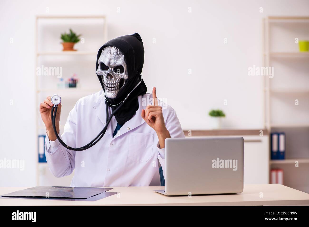 Male devil doctor working in clinic Stock Photo - Alamy