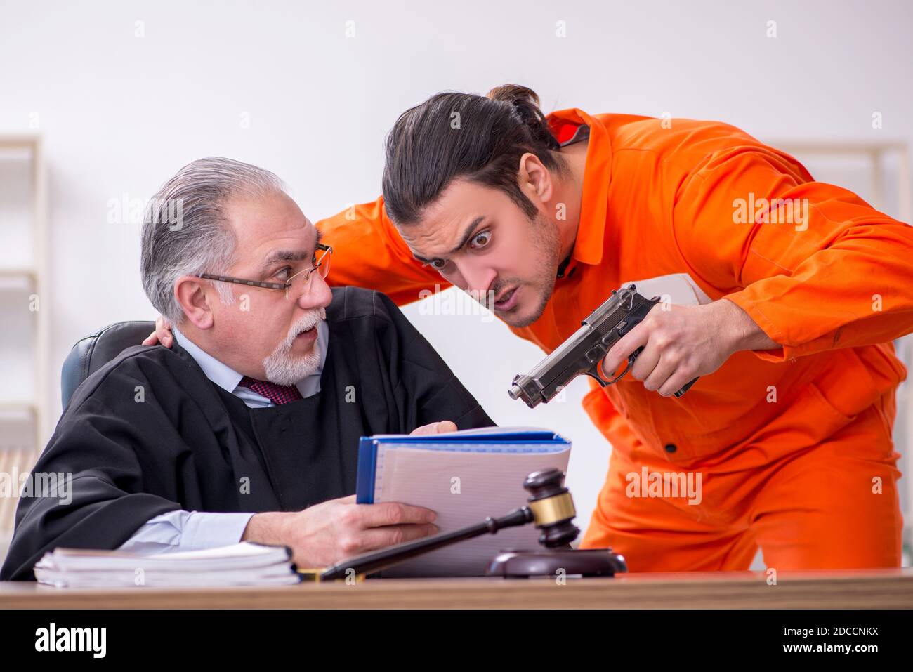 Old judge meeting with young captive in courthouse Stock Photo - Alamy