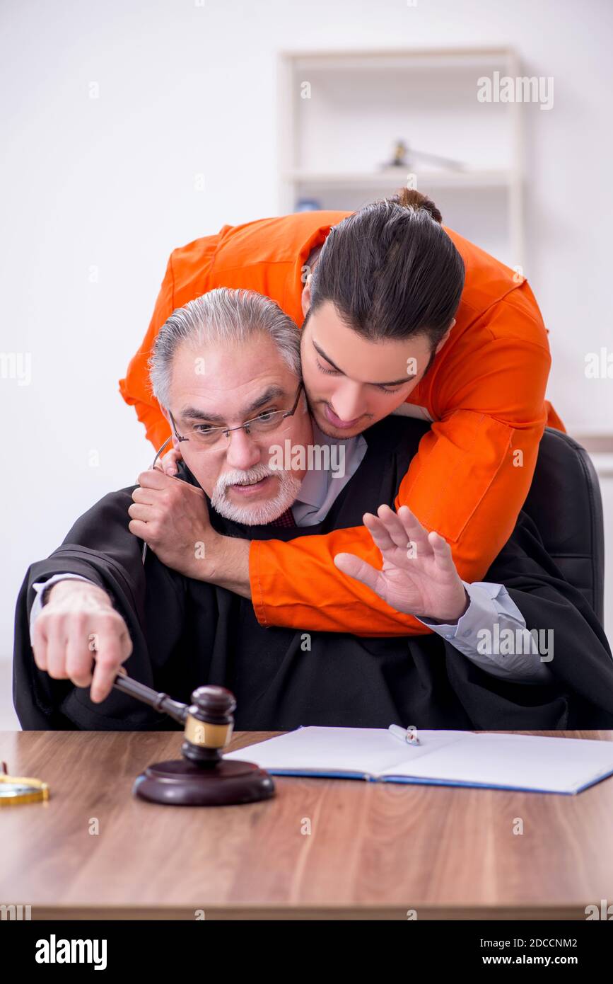 Old judge meeting with young captive in courthouse Stock Photo - Alamy
