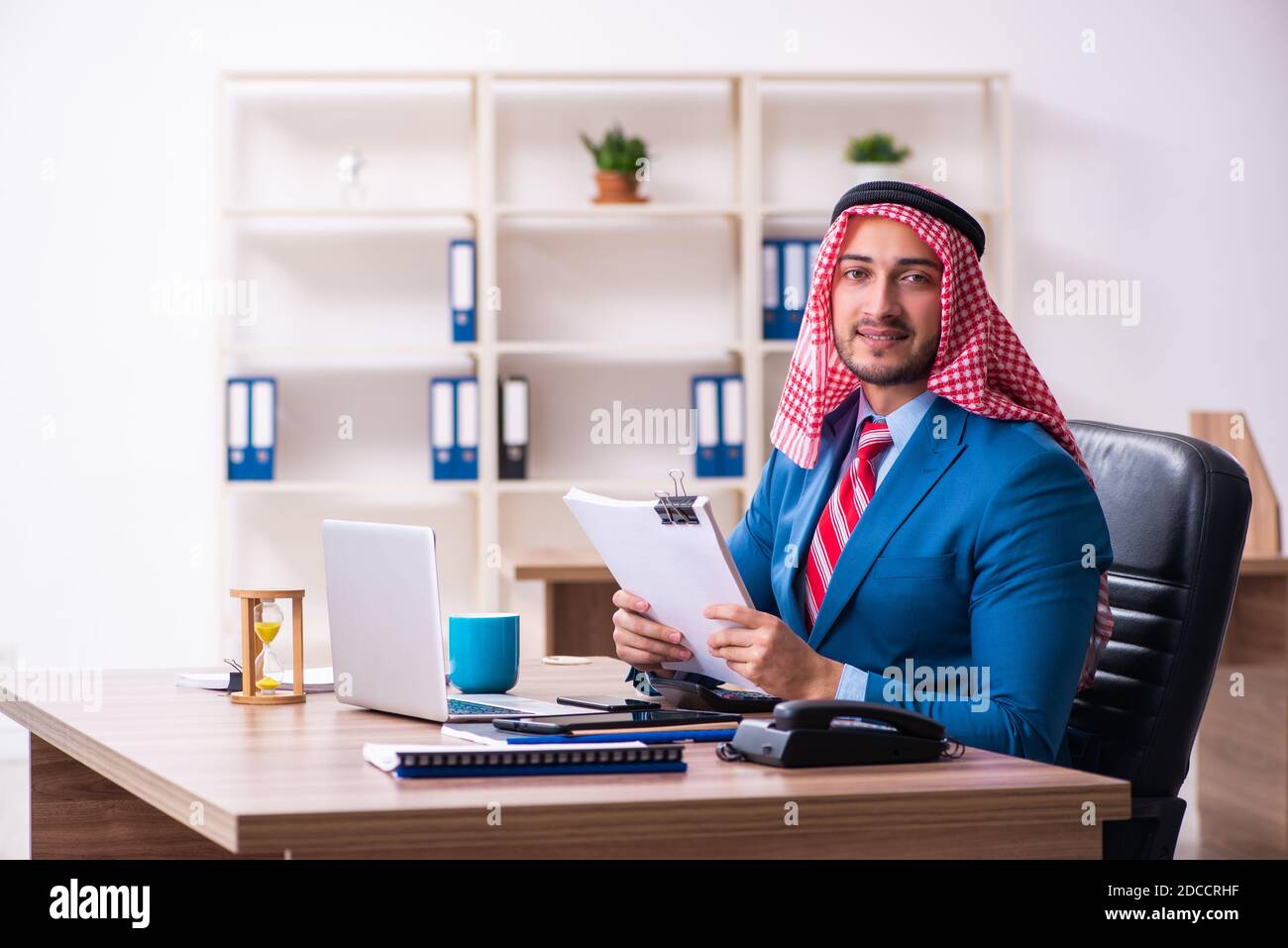 Young male arab employee working in the office Stock Photo - Alamy