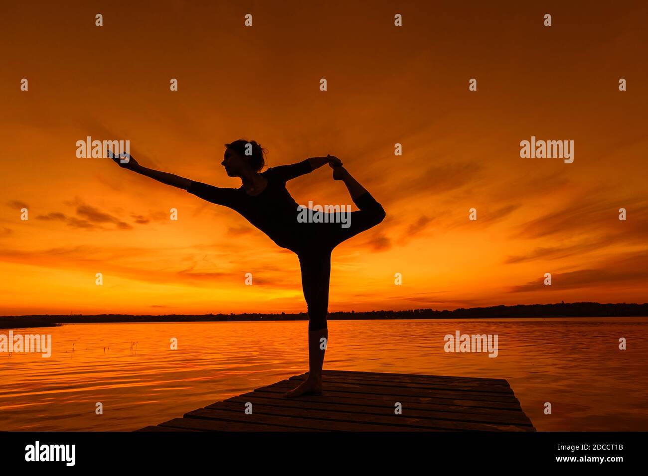 Woman practicing yoga posture Natarajasana / Lord of the Dance Pose ...