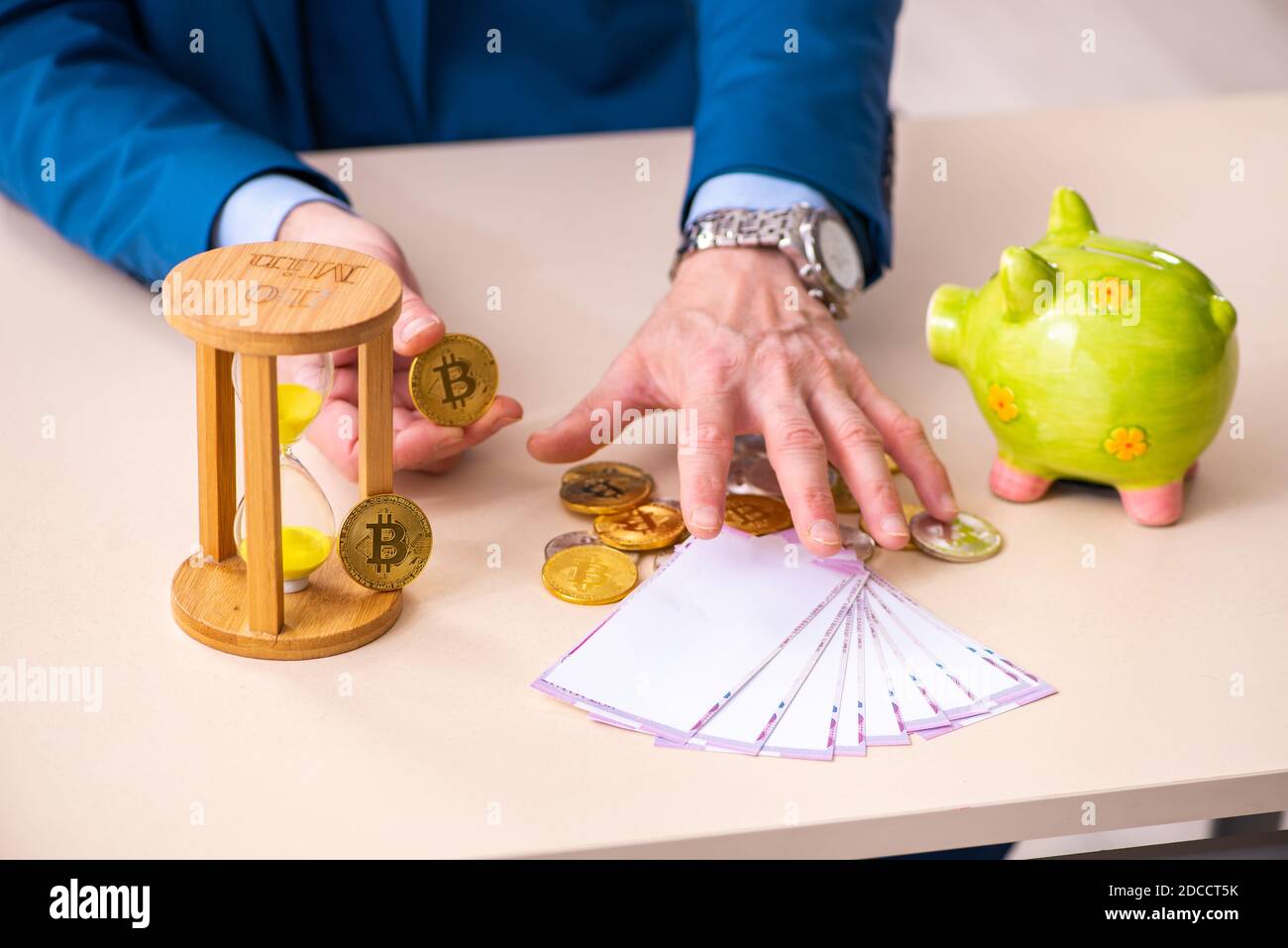 Old man earning money via internet in time management concept Stock ...