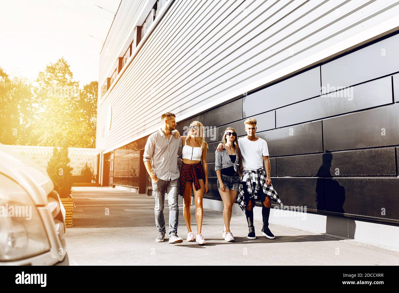 A group of young friends, girls and guys walking together in the fresh ...