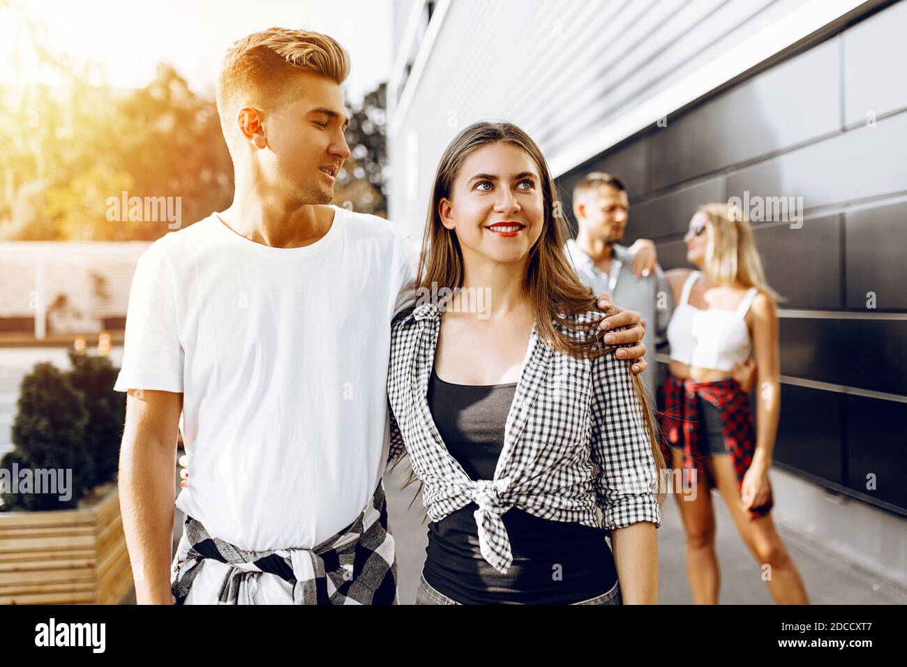 A group of young friends, girls and guys walking together in the fresh ...