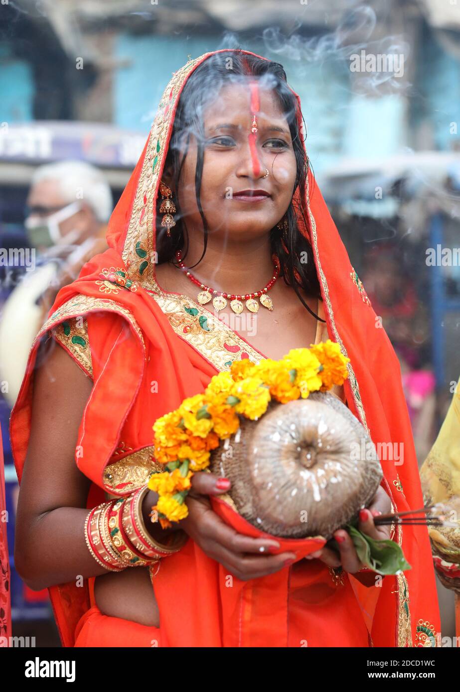 A Hindu woman devotees takes a bath before offering her prayers to the ...