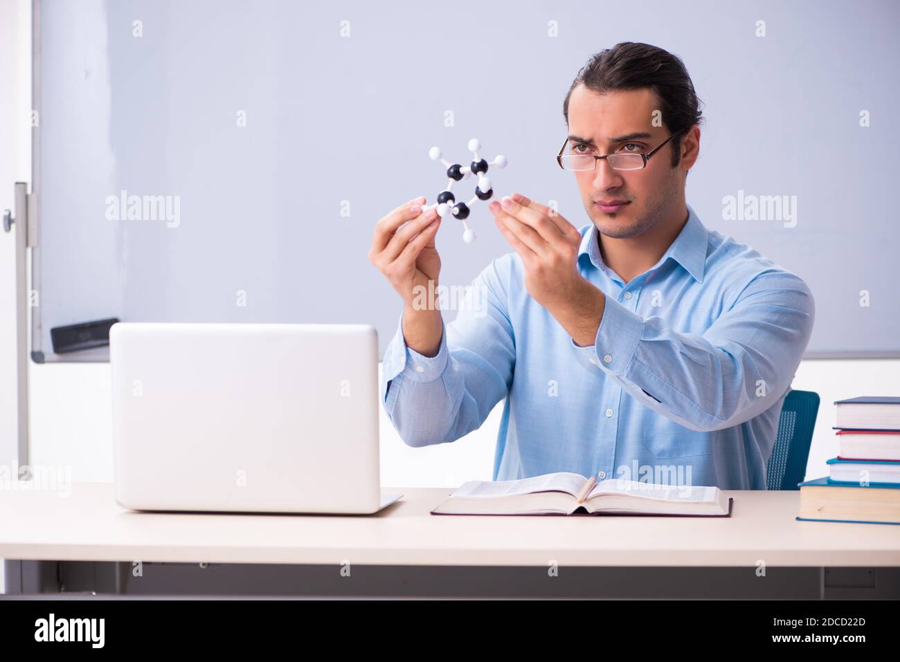Young physics teacher in front of whiteboard Stock Photo - Alamy