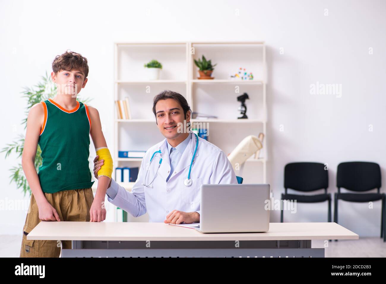 Sick boy visiting young doctor pediatrician Stock Photo - Alamy