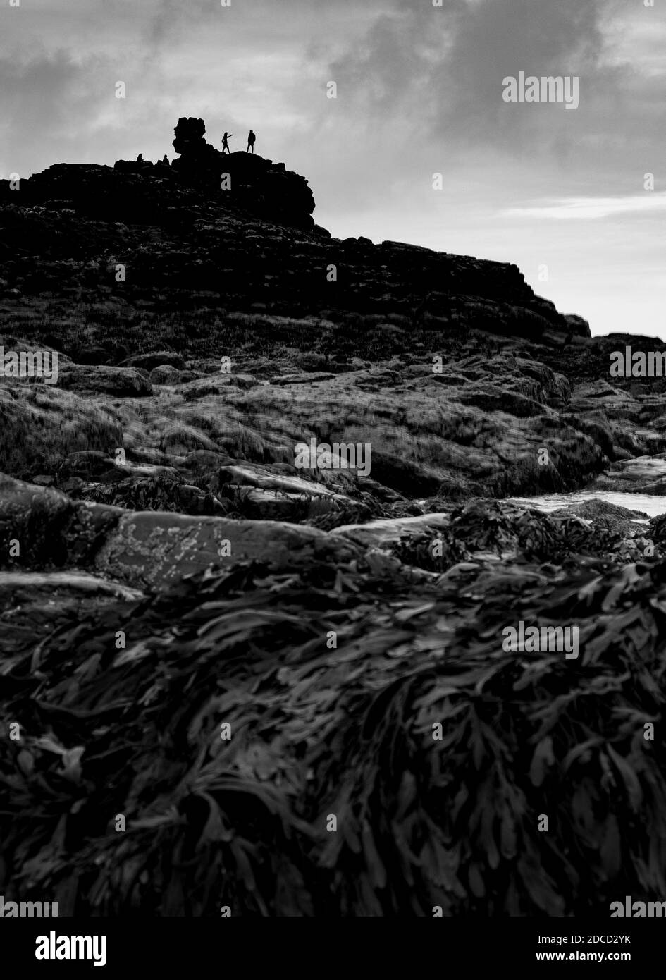 2 people silhouetted on rocks, Porthmeor Beach, St Ives blue flag beach ...