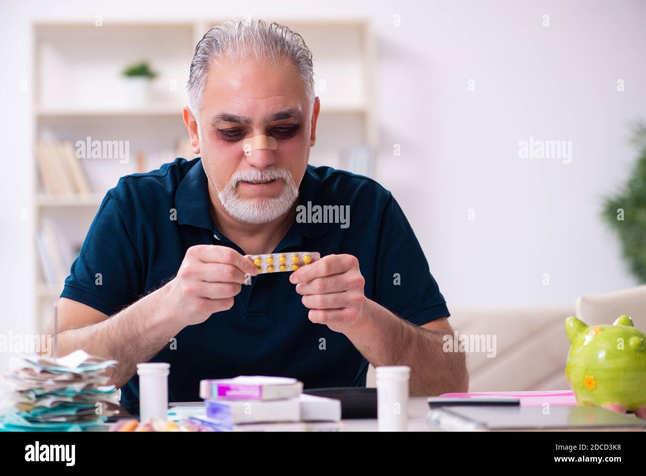 Old man in budget planning concept Stock Photo - Alamy
