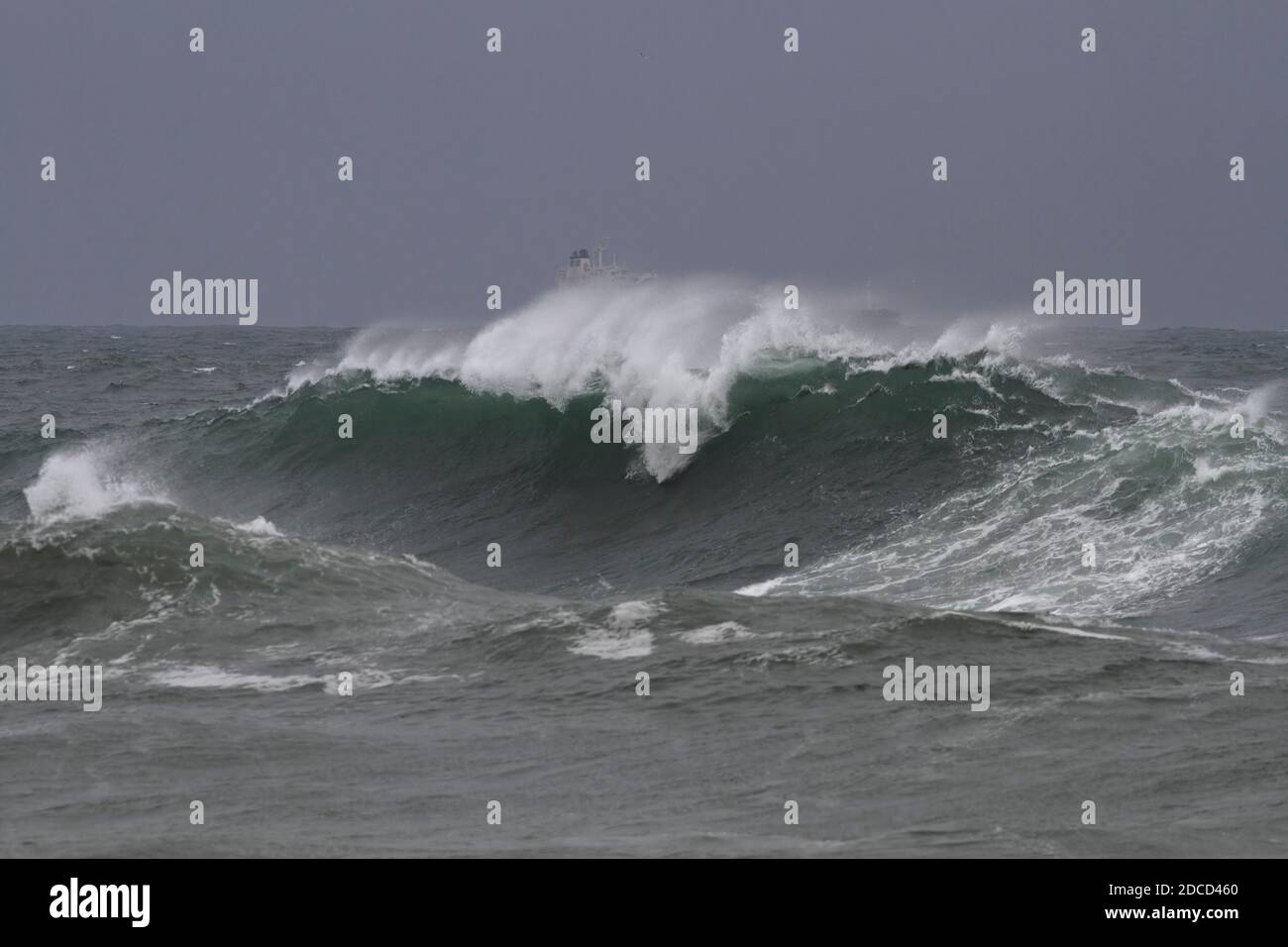 Windy wave in a stormy afternoon seeing a ship on the horizon Stock ...