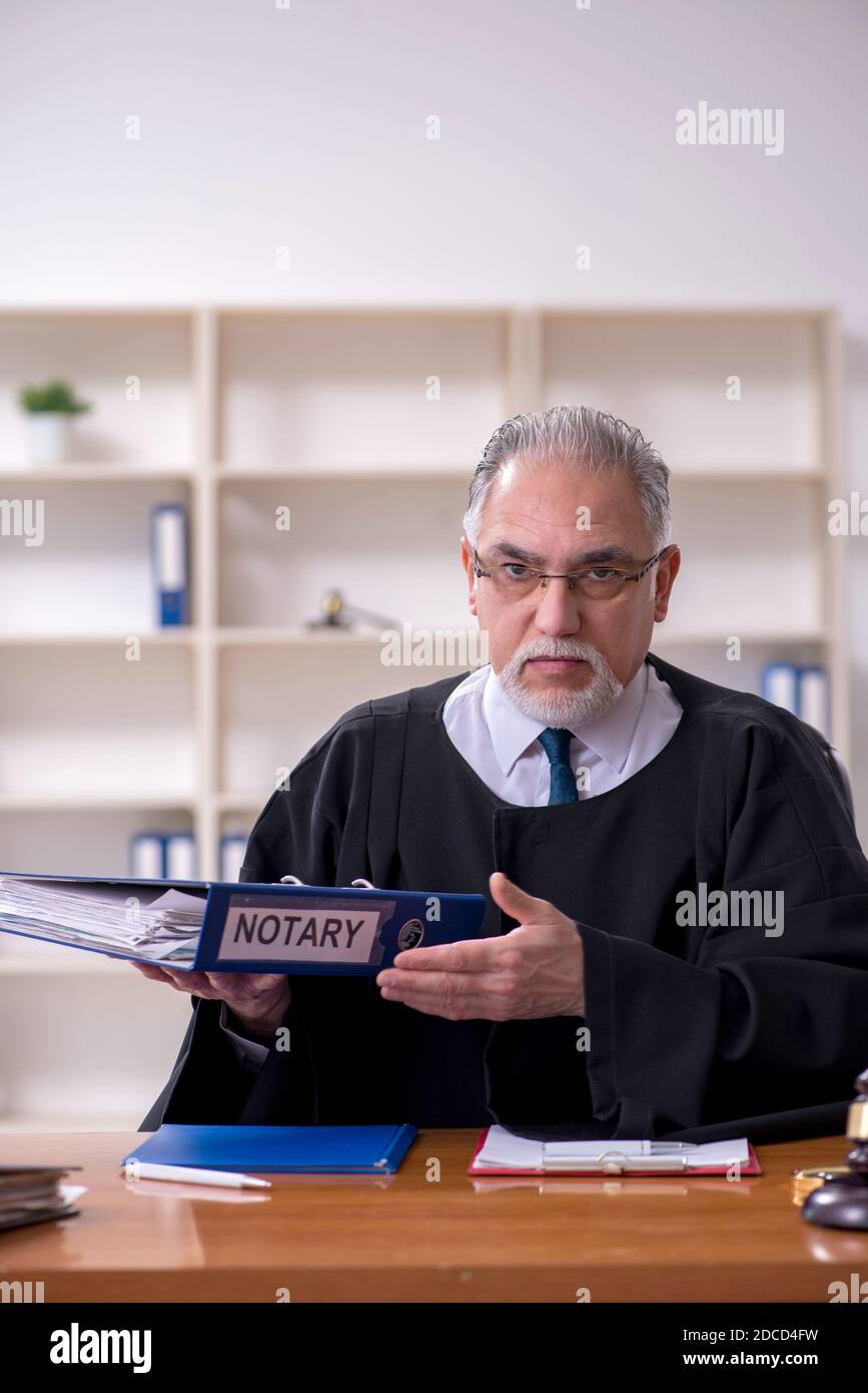 Old male judge working in the courthouse Stock Photo - Alamy