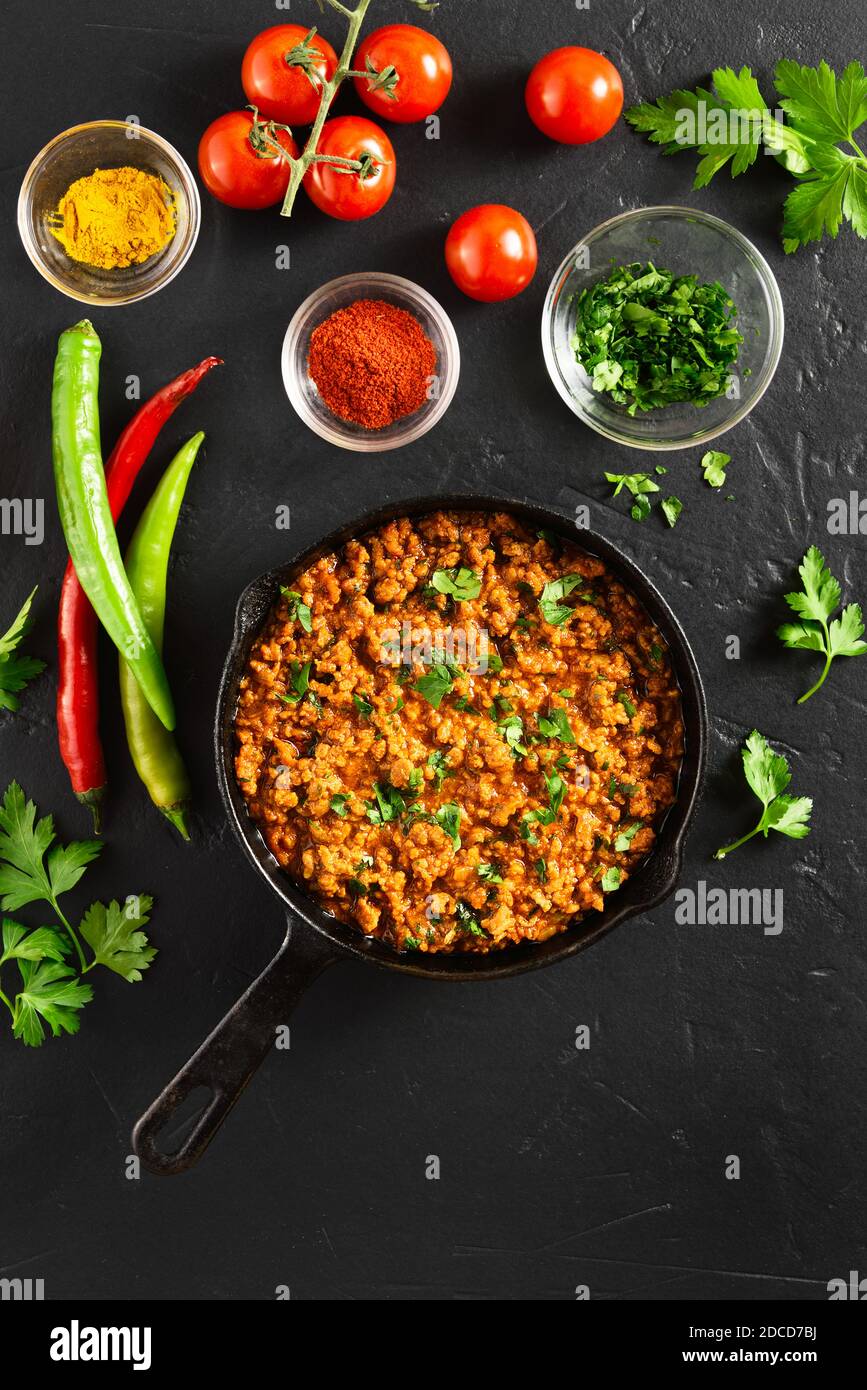 Keema curry in frying pan over black stone background. Indian and ...