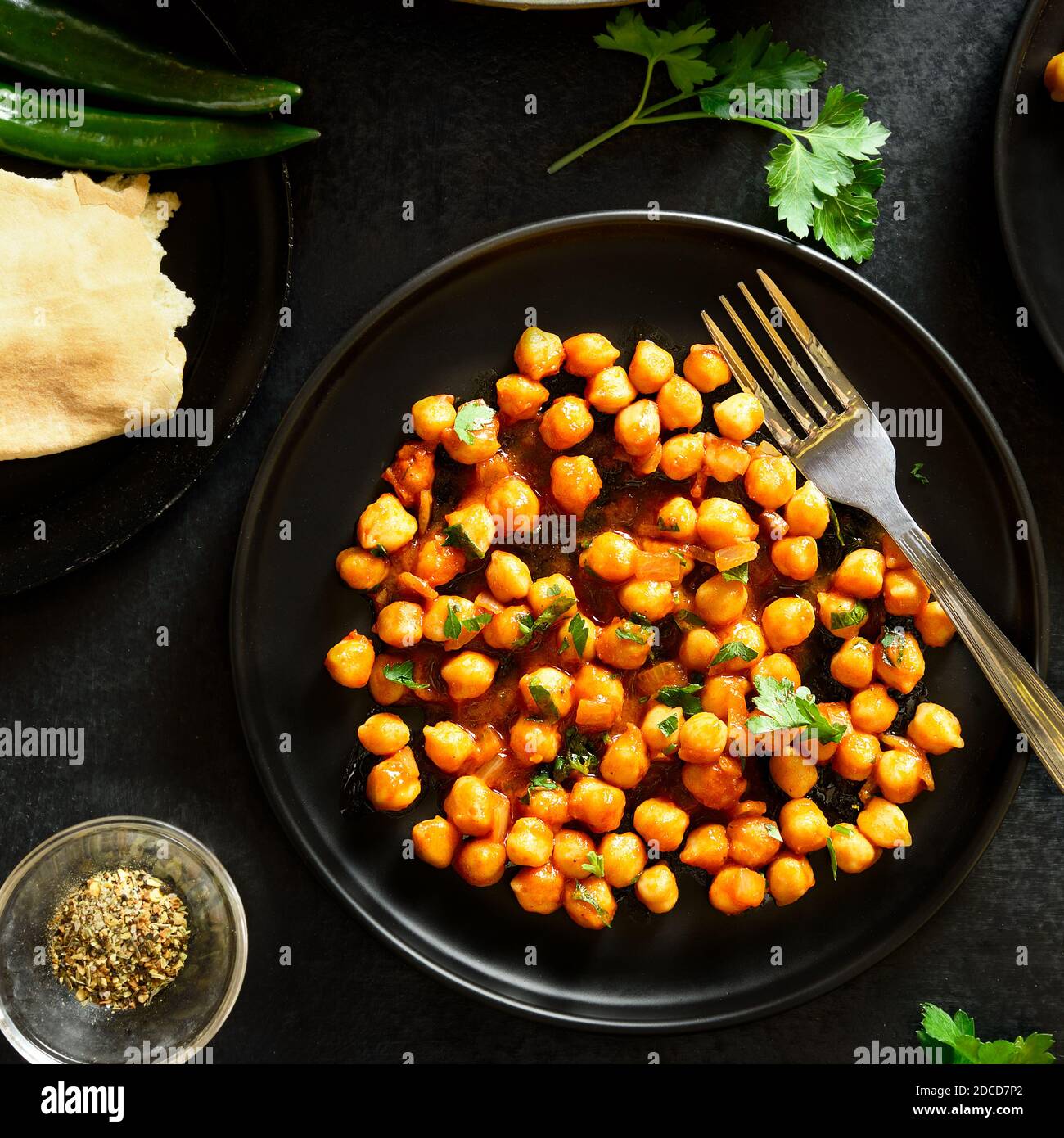 Indian style crispy roasted chickpeas over black stone background ...