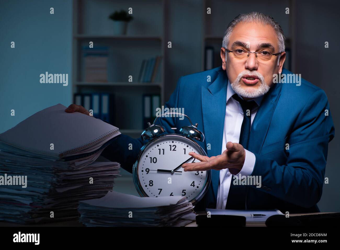 Old employee working late in the office Stock Photo - Alamy
