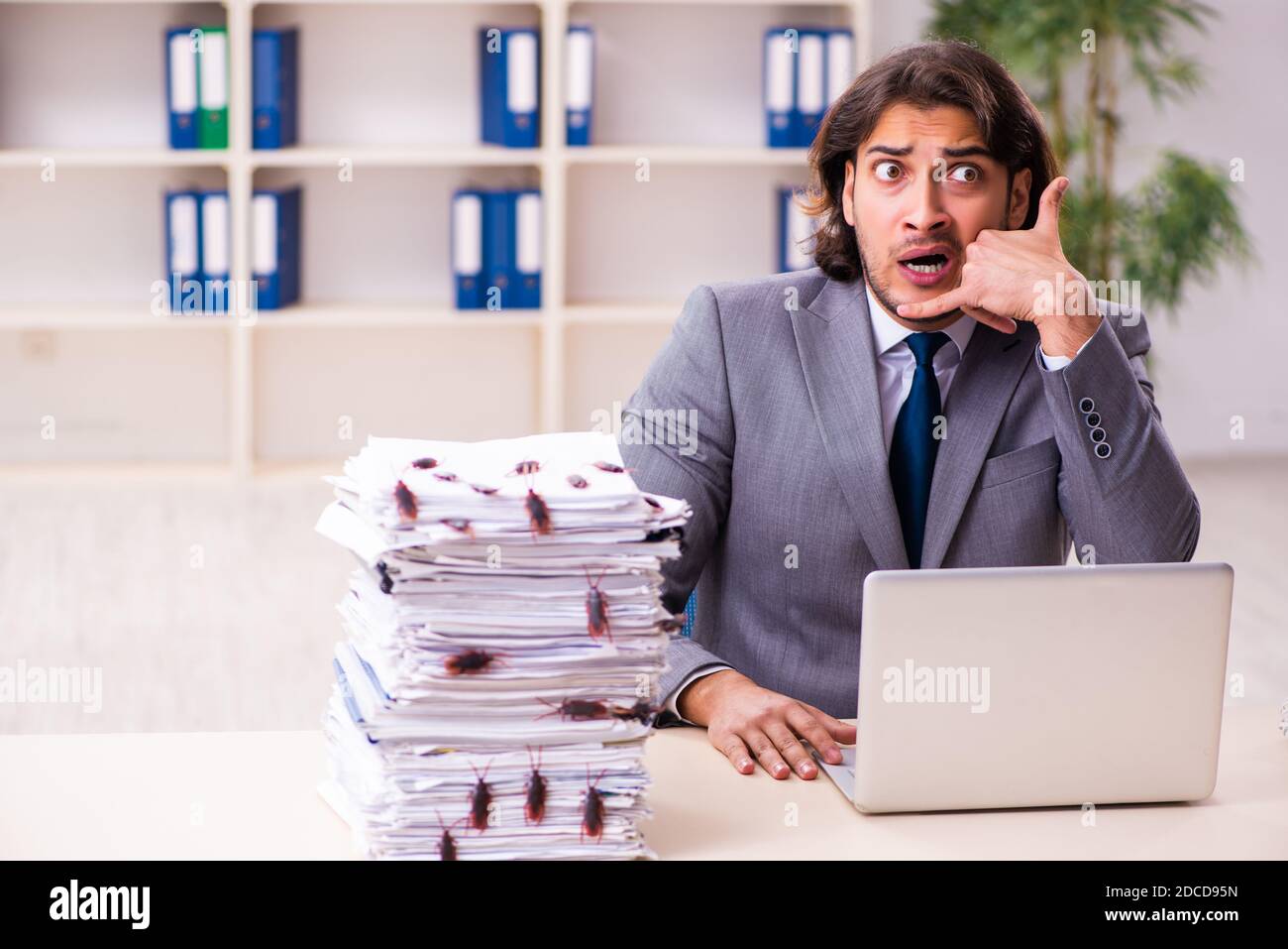 Young employee and too many cockroaches in the office Stock Photo - Alamy